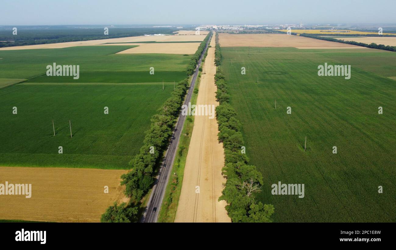 Automobile asphalt road with cars driving between agricultural fields ...