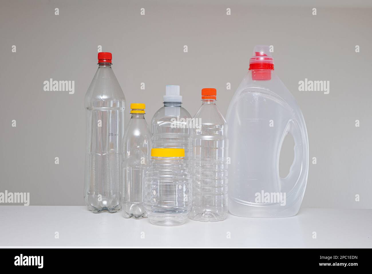 Variety of empty transparent plastic bottles without a label, ready to ...