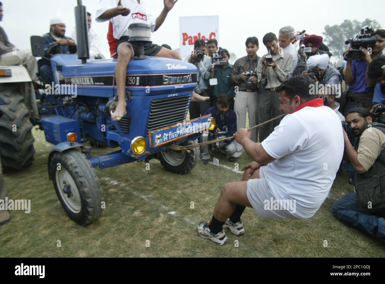 An Indian man, pulls a tractor with his teeth at the rural Olympics in ...