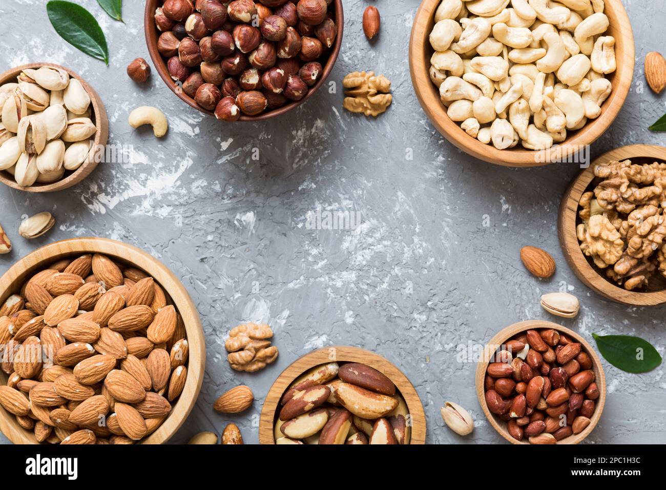 mixed nuts in wooden bowl. Mix of various nuts on colored background ...