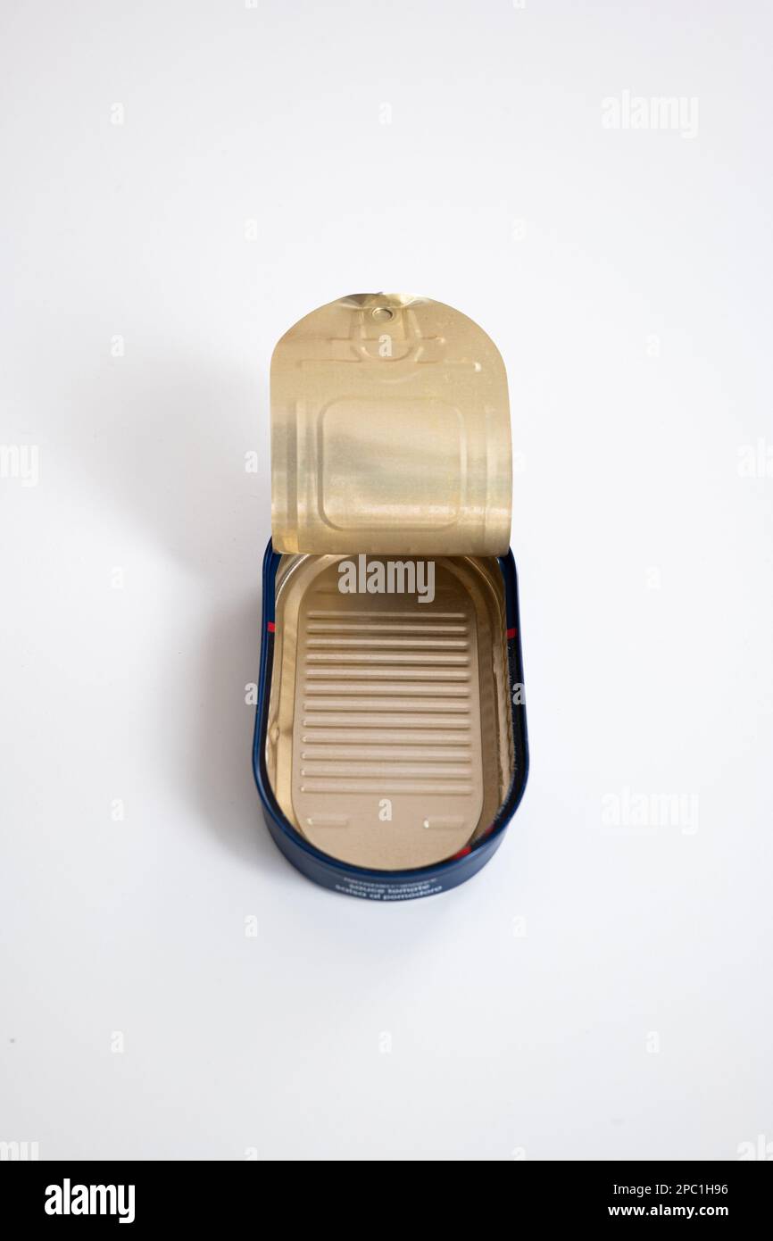 Empty and opened clean metal tin can on a white surface. Close up top ...