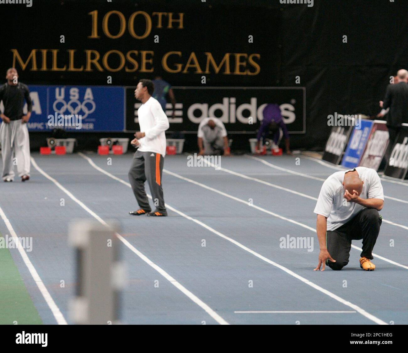 Maurice Greene, right, pauses on the track before competing in the 60 ...