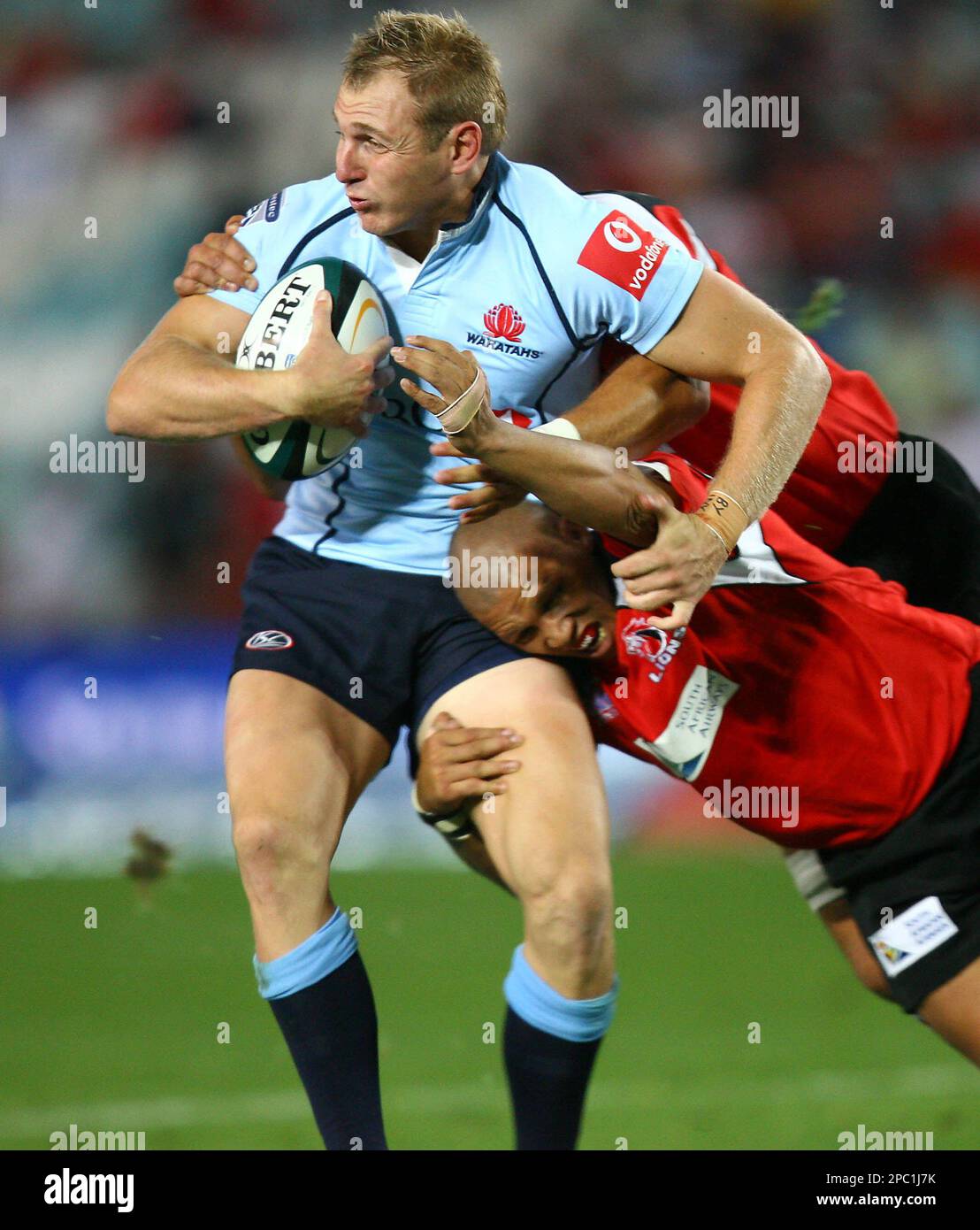 Australia's Warratahs, Peter Hewat(left) is tackled by South Africa's ...