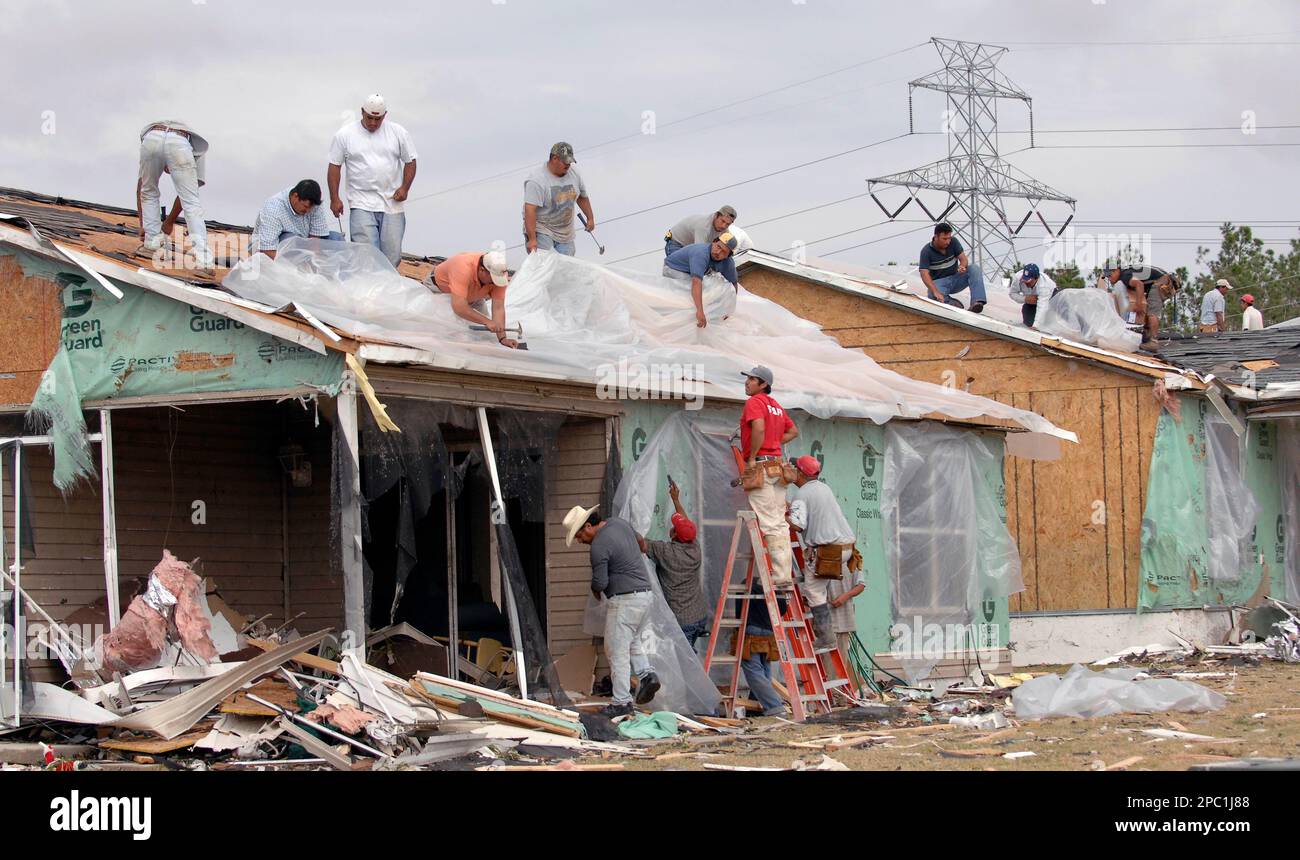 Clean up crews begin work to repair damage to homes from a tornado that ...