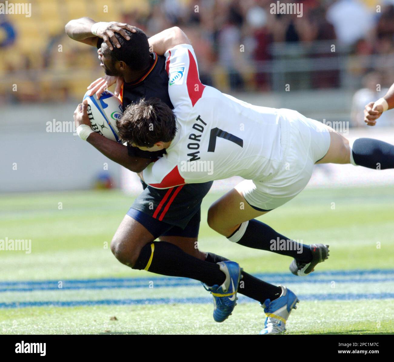 England's Nils Mordt, right, tackles Papua New Guinea's Joseph Wamapiri ...