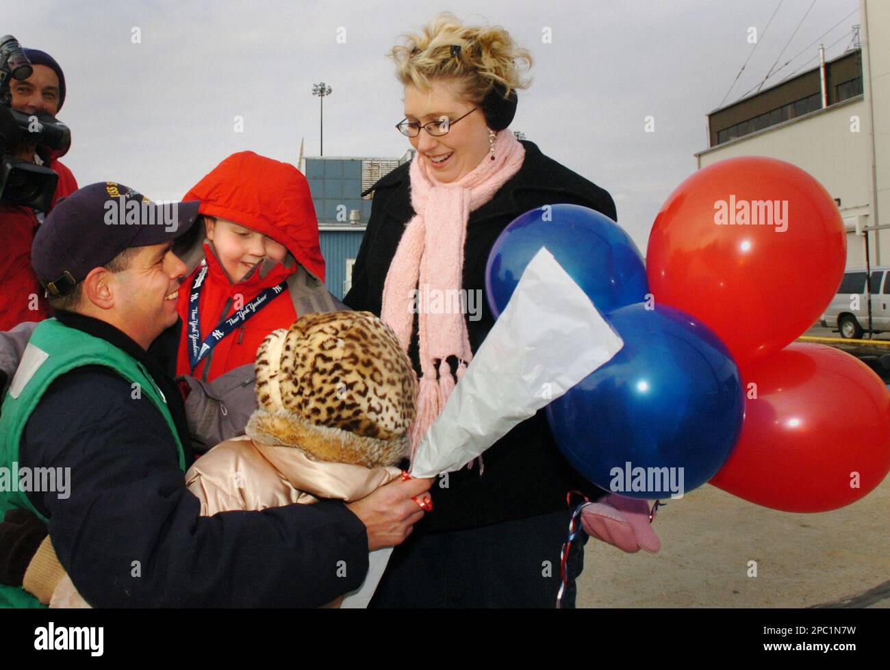 Chief Petty Officer Steve Bosco hugs his family after returning from a ...