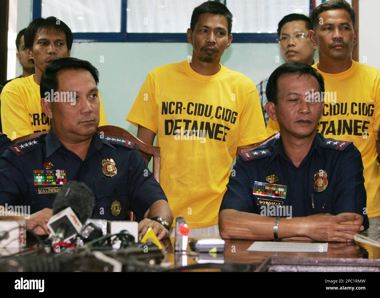 Philippine National Police Chief Oscar Calderon, left seated, presents ...