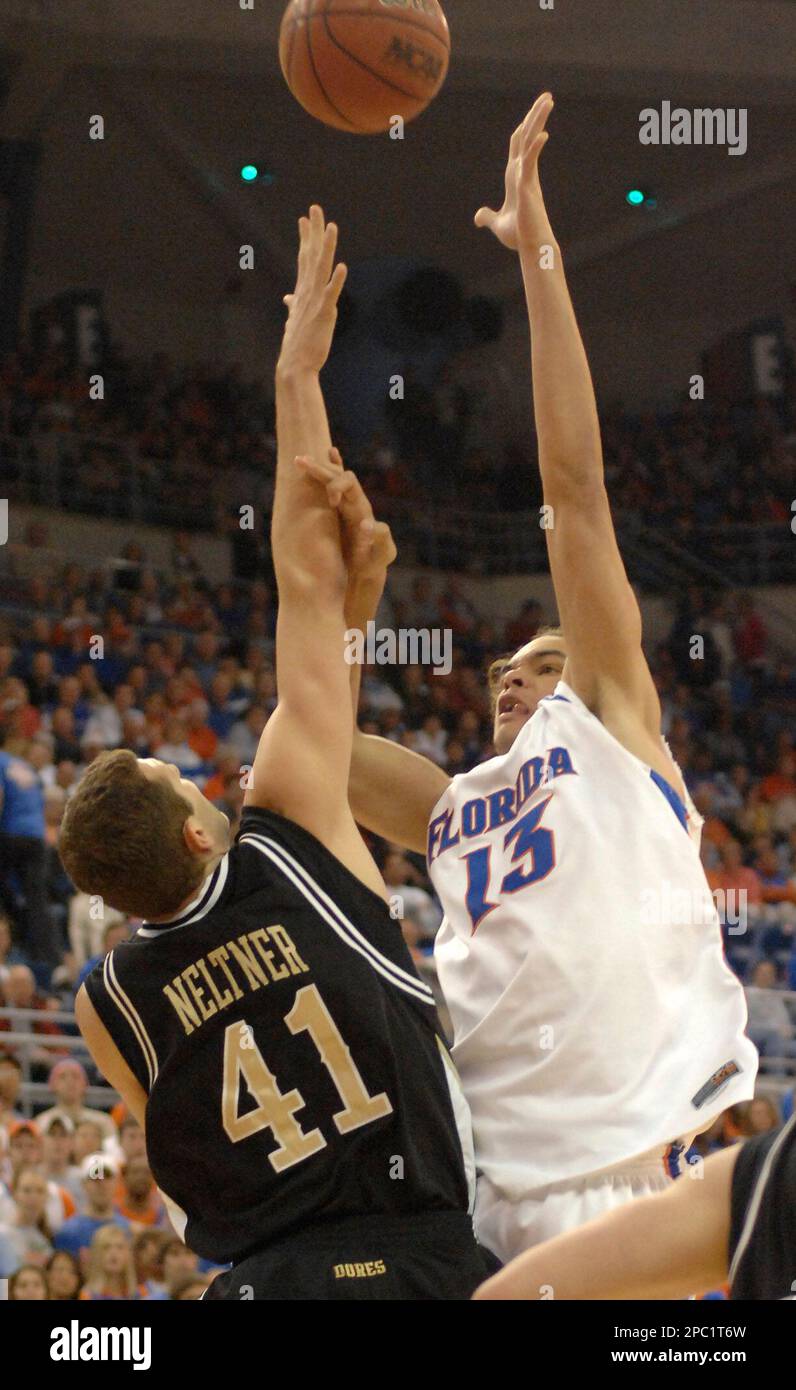 Florida's Joakim Noah (13) gets the ball over Vanderbilt's Ross Neltner ...
