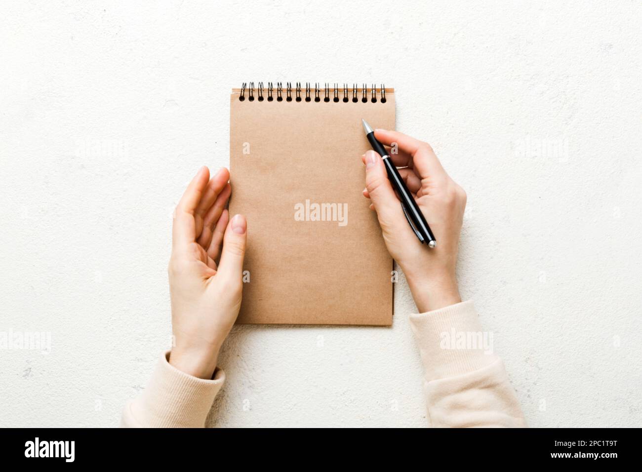 Woman hand with pencil writing on notebook. Woman working on office ...
