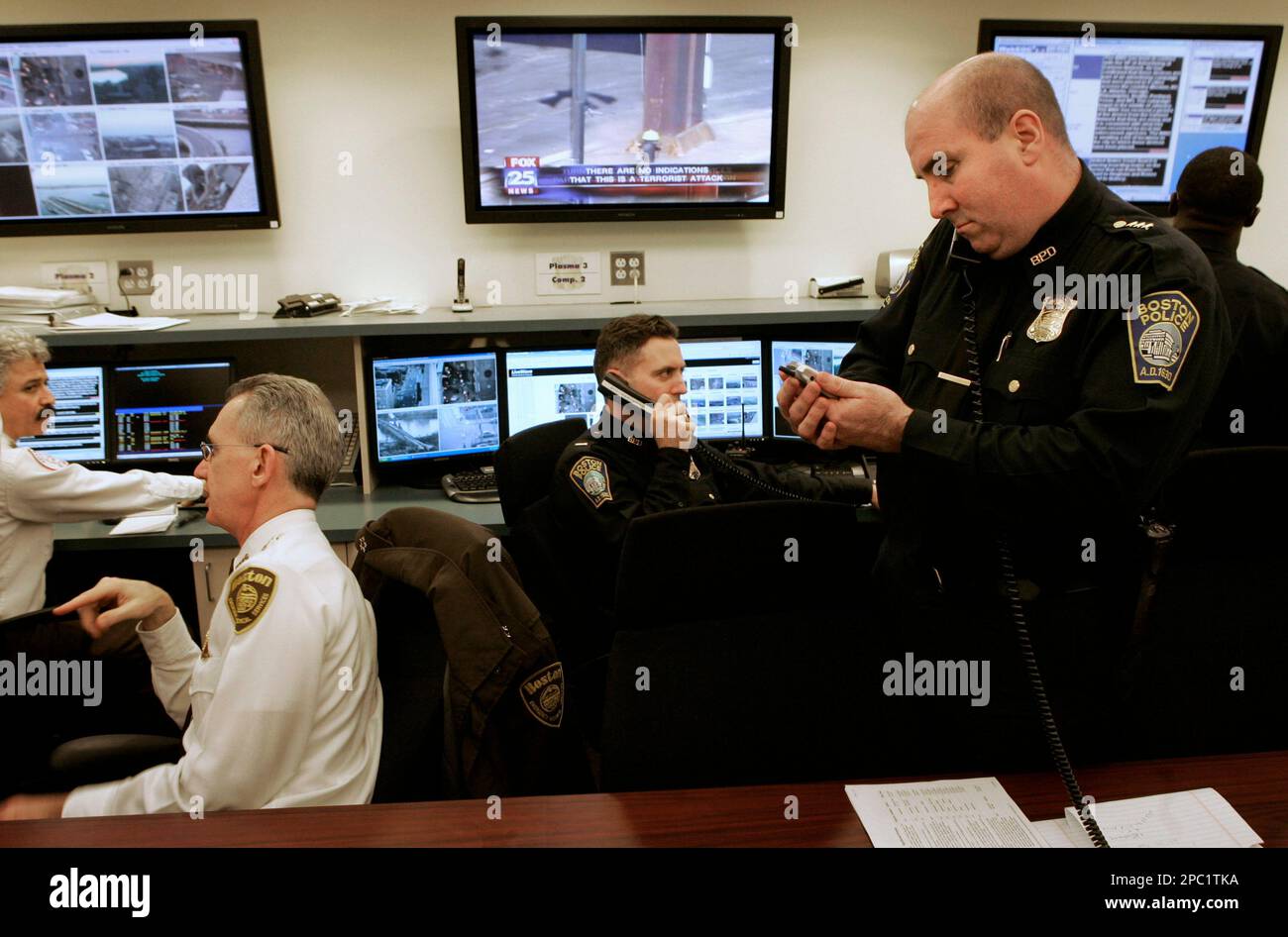Boston Police Deputy Supernatant Daniel Linskey, right, uses a mobile ...