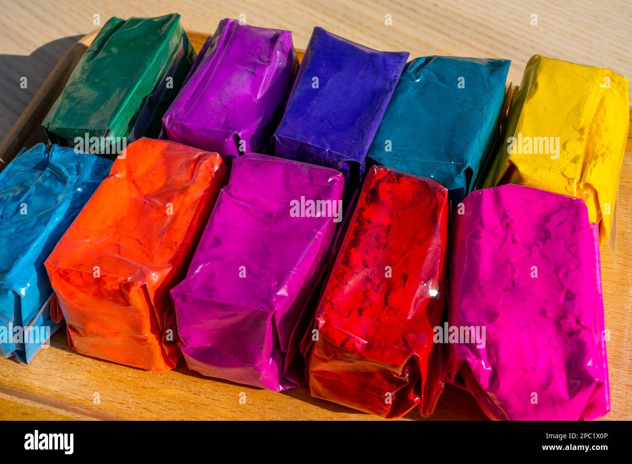 Dry colours Gulal packed in plastic pack placed at market shop for sale ...