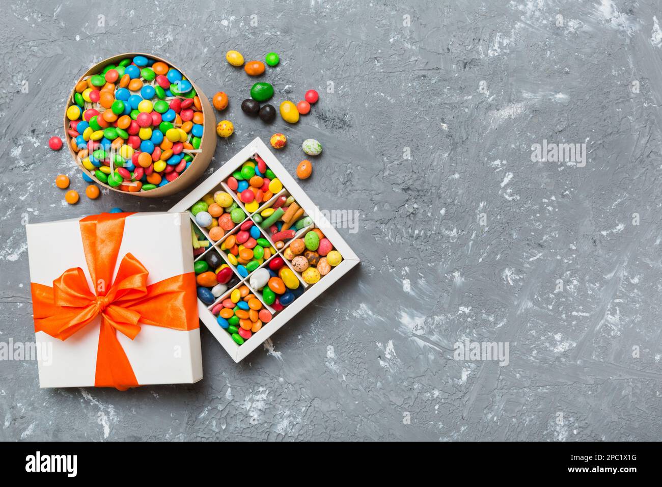 Set of different sweet candy in a paper box with a satin ribbon on a ...