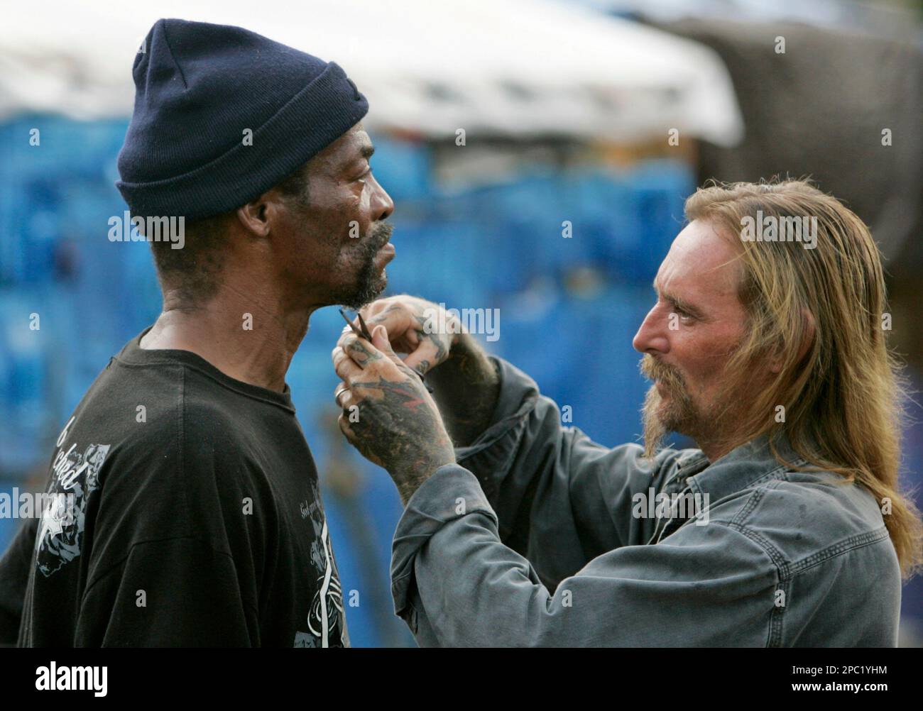 Homer Crawford, 56, left, has his beard trimmed by Robert Joseph, 42 ...