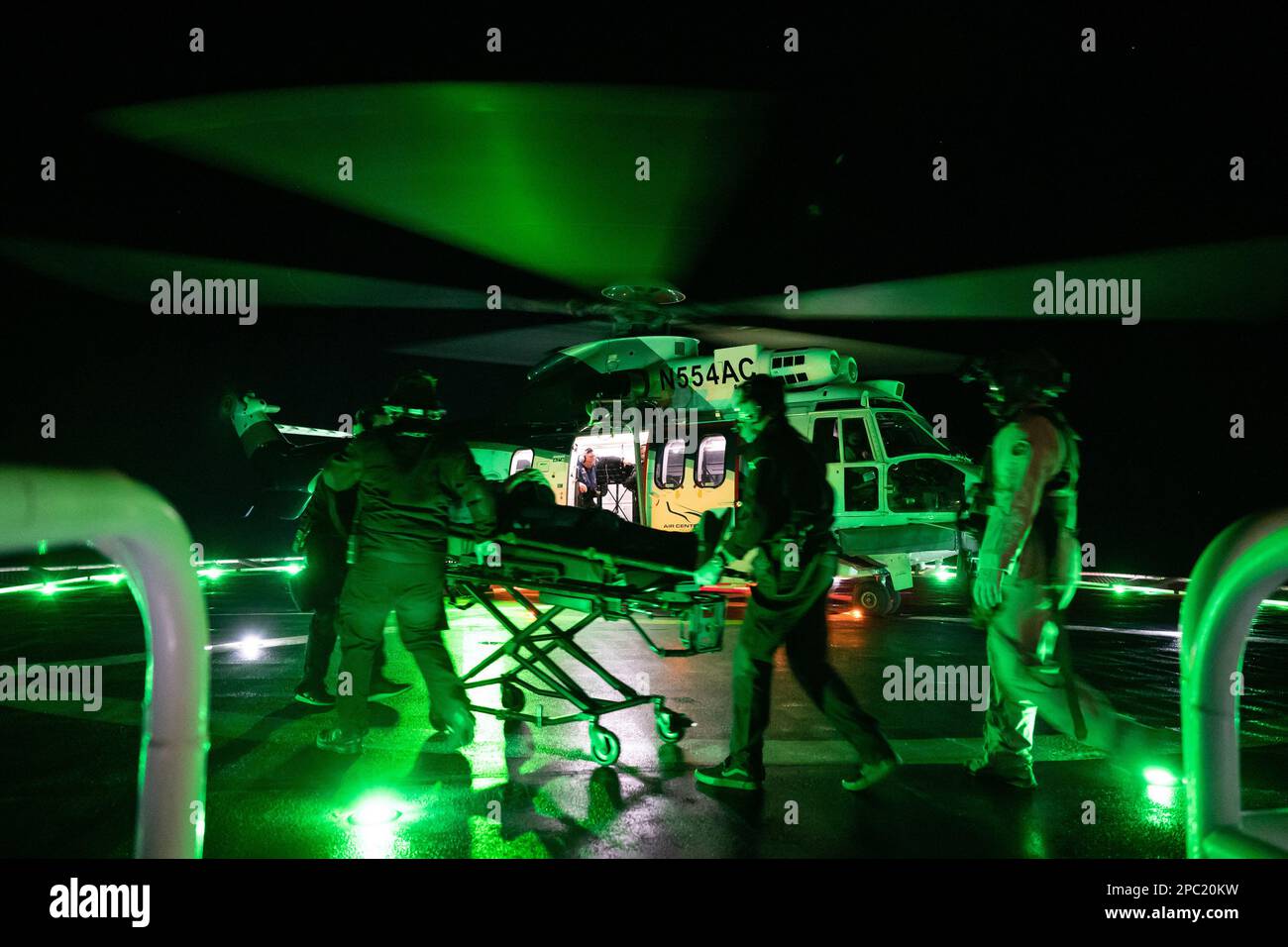 NASA Astronaut Josh Cassada is helped onto a helicopter onboard the ...