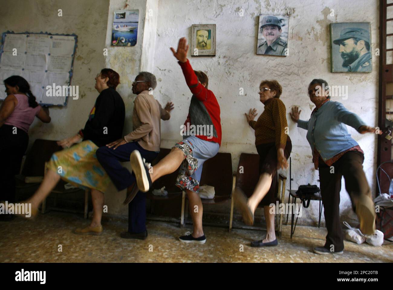 A group of elderly Cuban women practice their daily exercises under ...