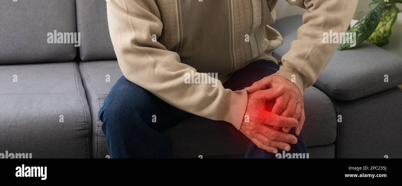 Male injured knee. Sore spot highlighted by red marker. Man touches him ...