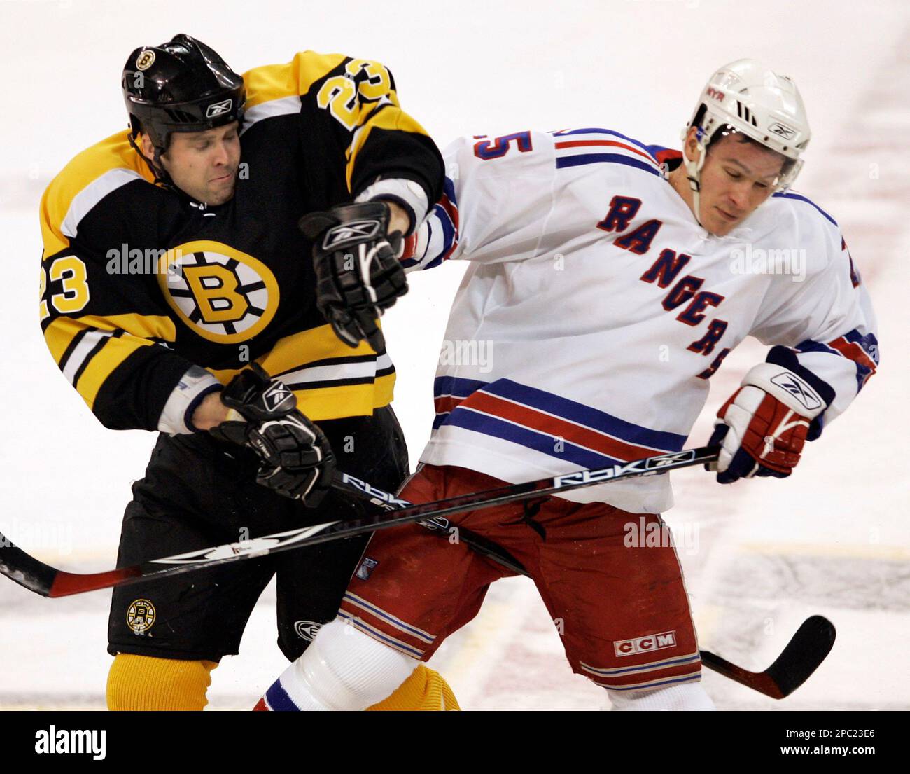 Boston Bruins Paul Mara (23) grapples with New York Rangers Petr Prucha ...
