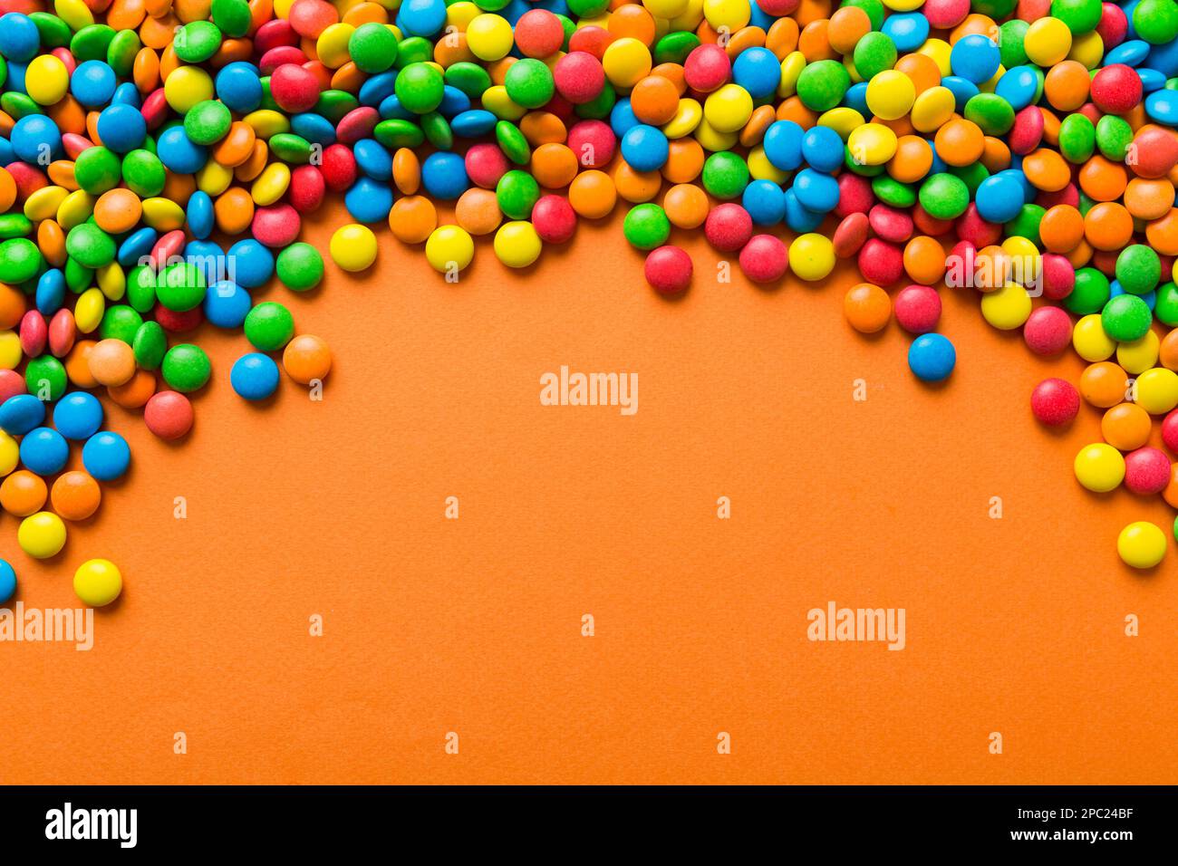 Mixed collection of colorful candy, on colored background. Flat lay ...