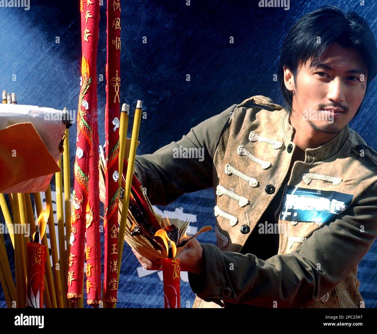 Hong Kong pop star Nicholas Tse burns imitation money at the ...