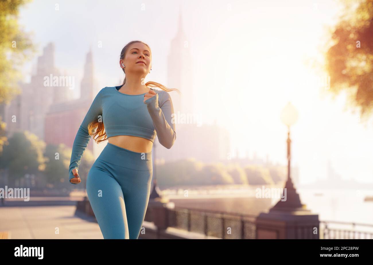Athletic woman is running on rooftop of parking, garage on sunset ...