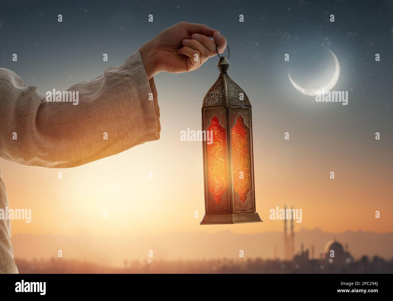 Ornamental Arabic lantern with burning candle glowing at night mosque ...