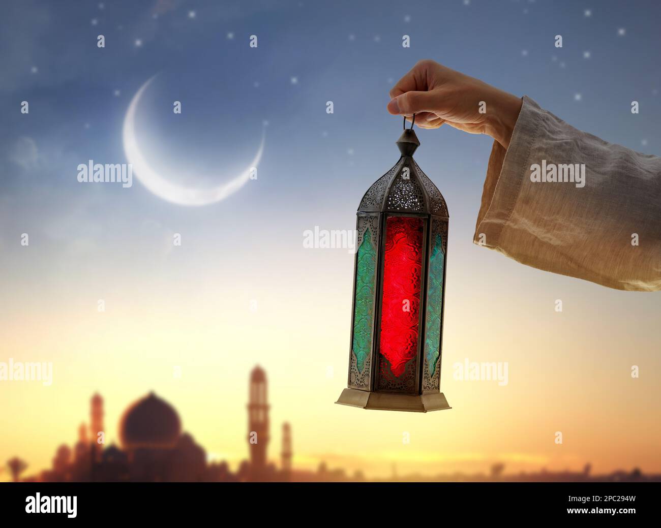 Ornamental Arabic lantern with burning candle glowing at night mosque ...