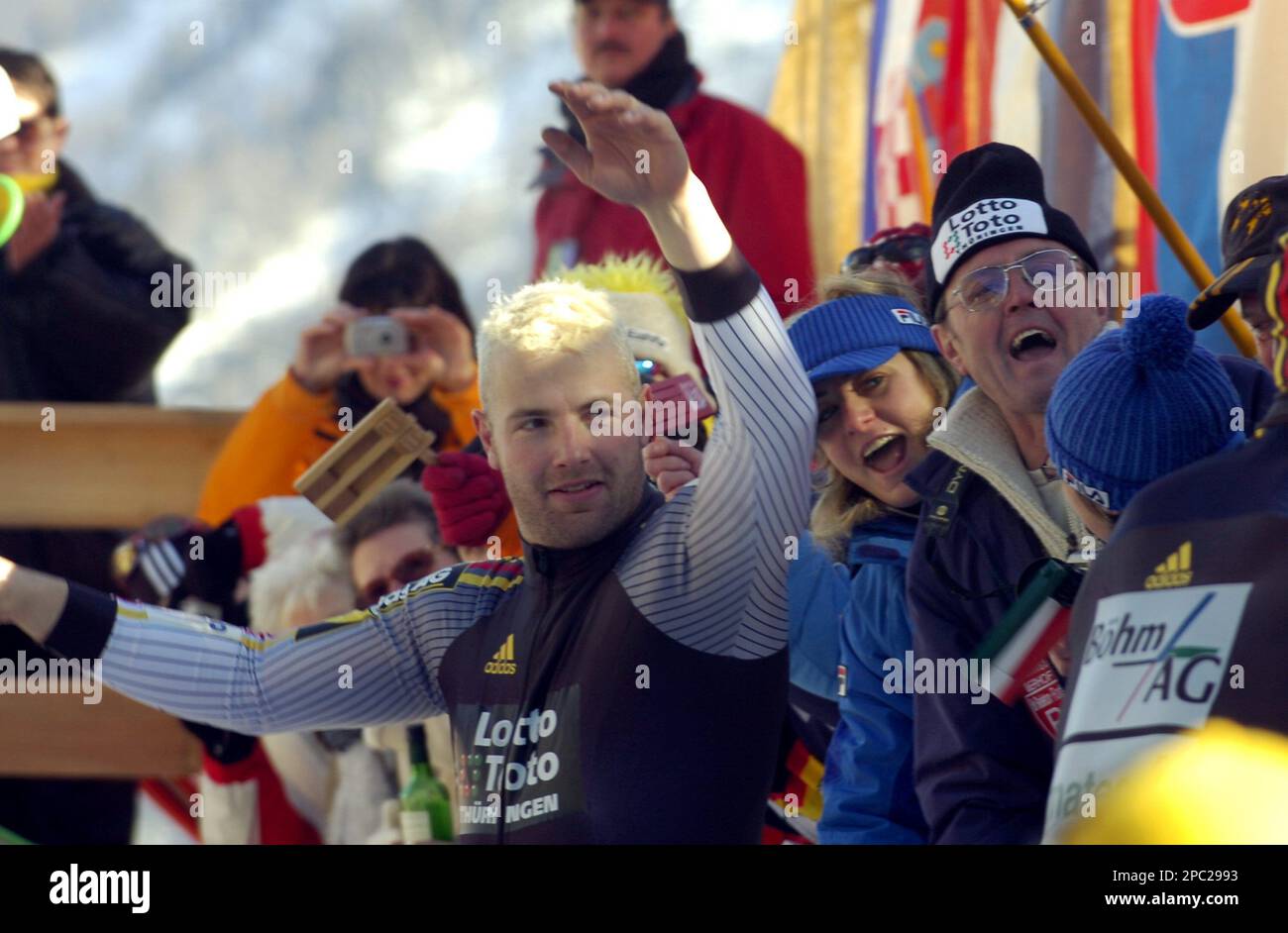 Gold medal winner Andre Lange, from Germany celebrates with fans after ...