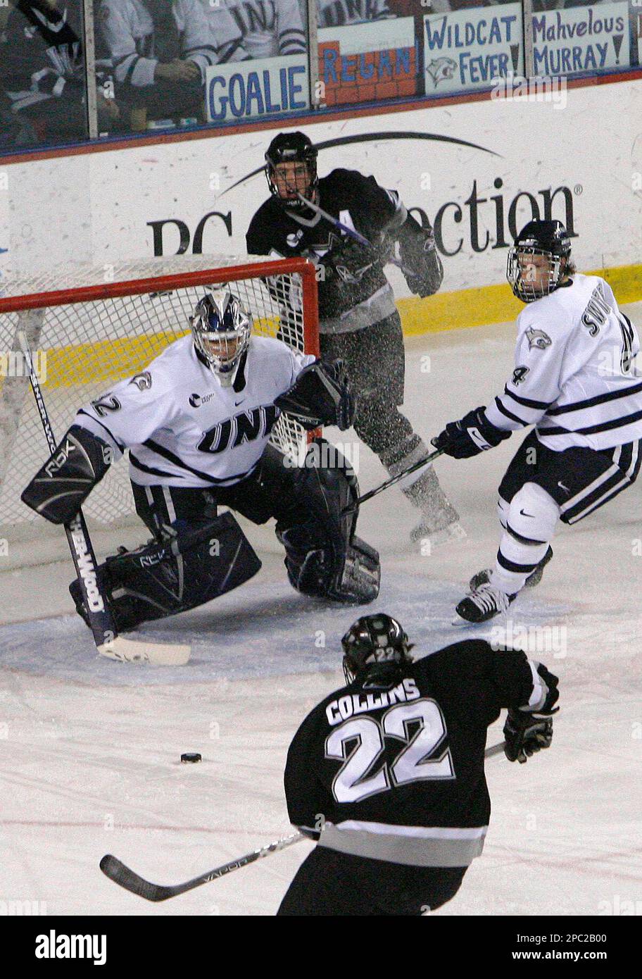 New Hampshire's Craig Switzer, right, watches as goalie Kevin Regan ...