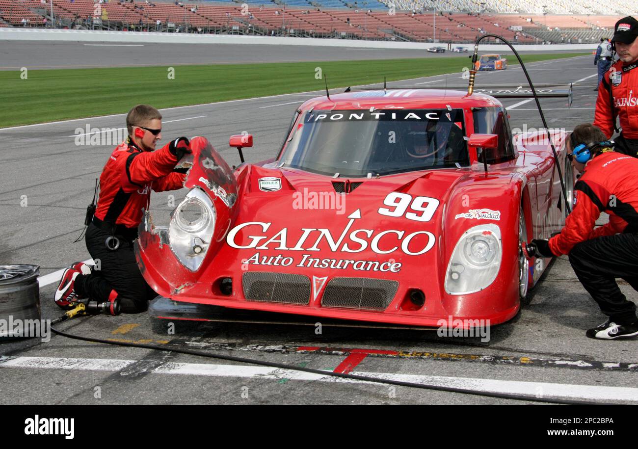 The crew of the 99 Pontiac Riley fixes the right front fender after an ...
