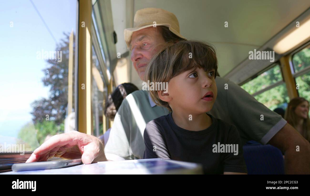 Grandparent traveling by train with grandchild. Two different ...