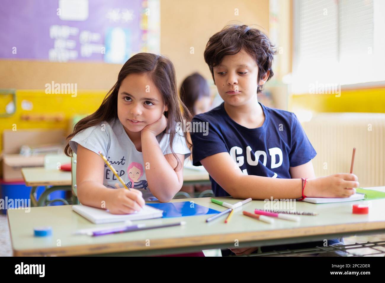 Caucasian boy and girl at school. Classmates learning together. Primary ...