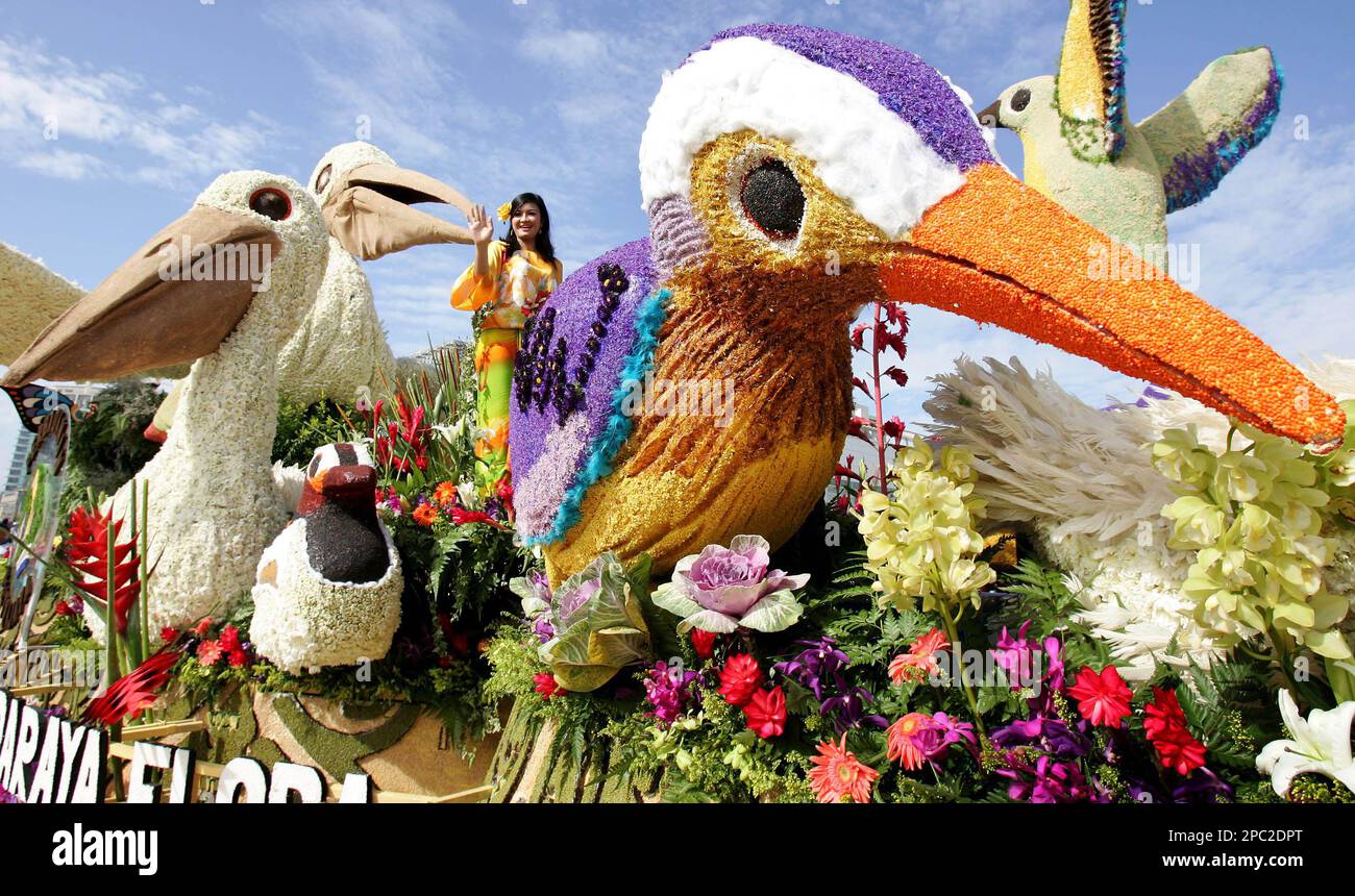 A participant waves to the crowds as she stands with the birds, made of ...