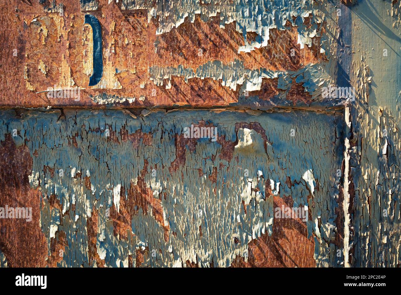 Rusted door detail with flaking paint in warm natural light Stock Photo ...