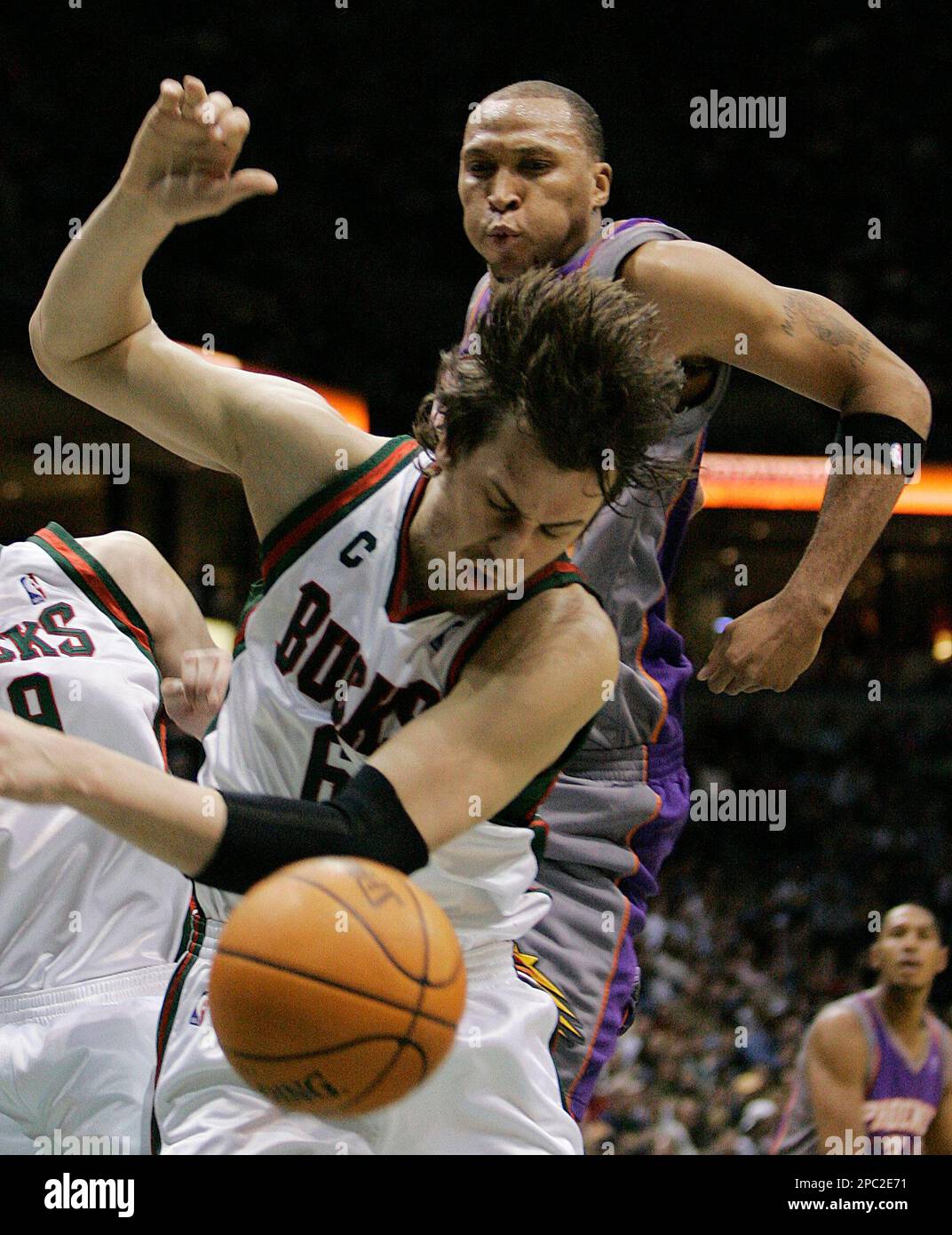 Phoenix Suns center Shawn Marion, rear, fouls Milwaukee Bucks center ...