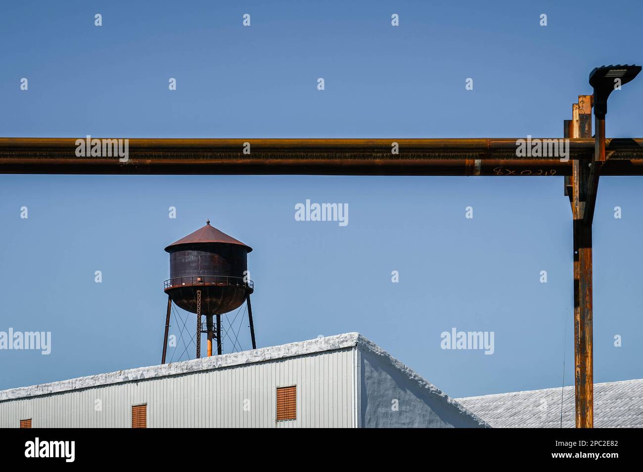Corrosion on water tower and pipes with white rooves Stock Photo - Alamy