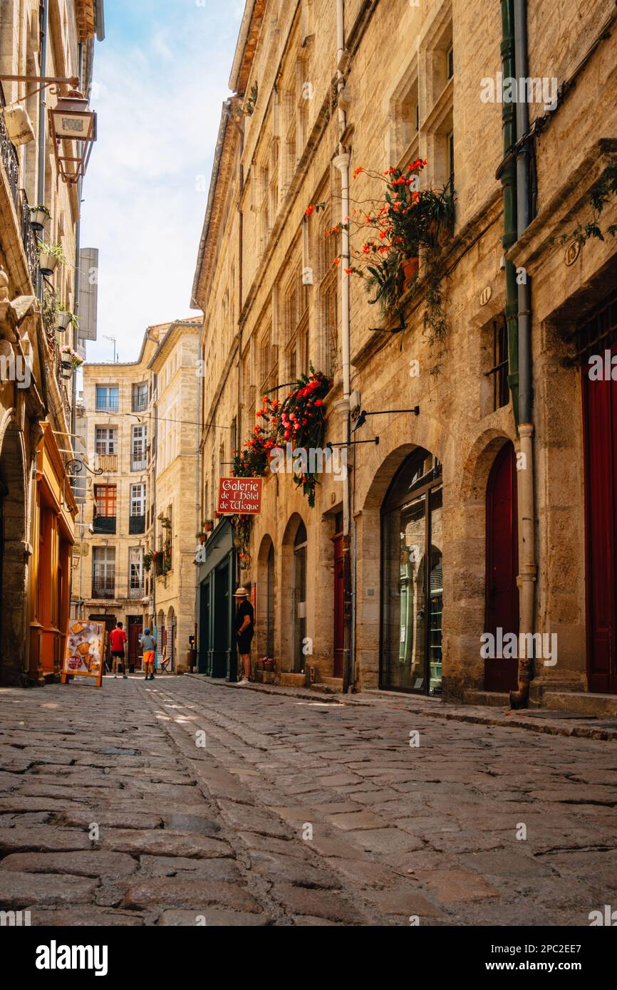Quaint shops and facades on the cobblestone paved street of Rue de la ...
