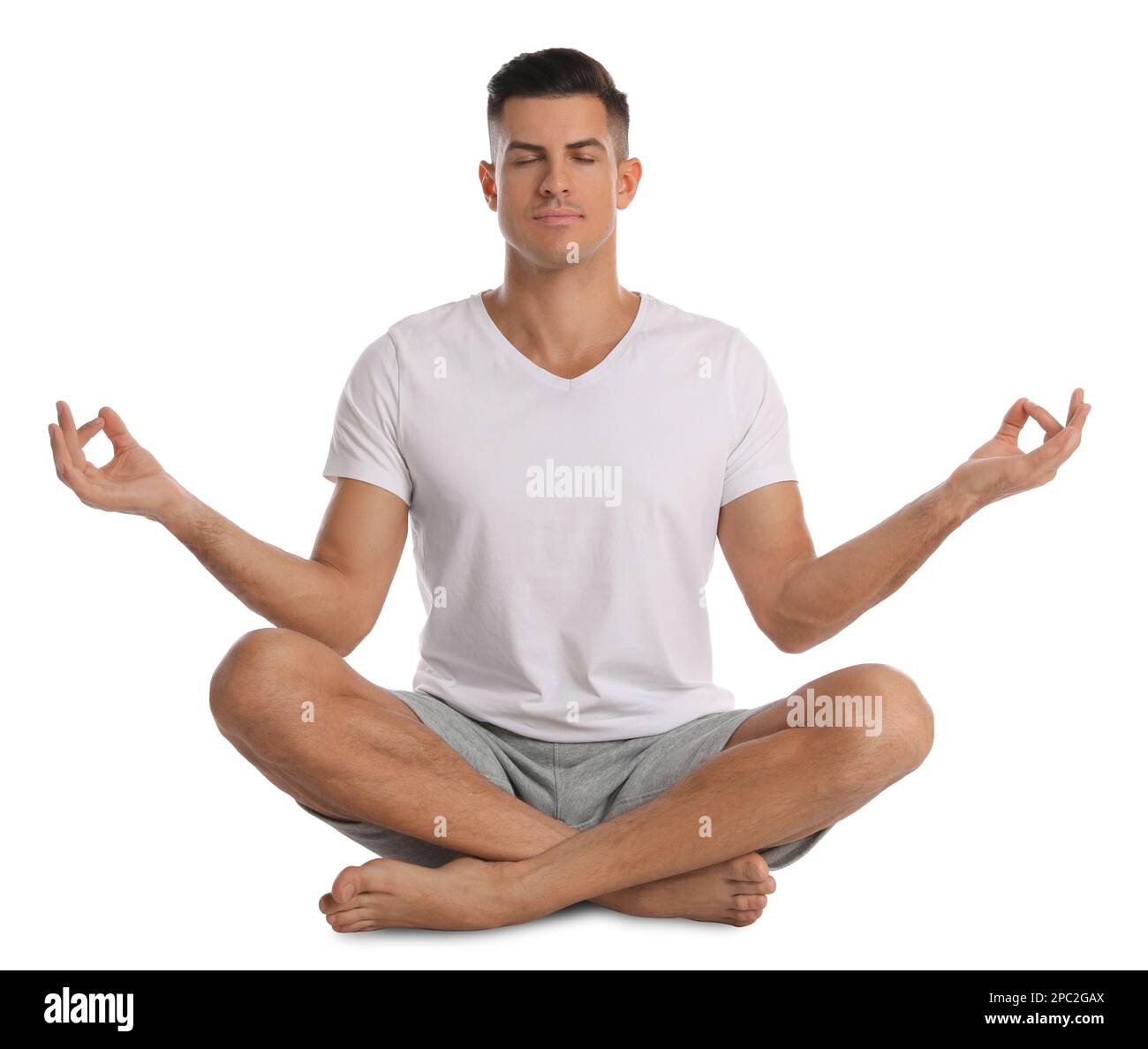 Handsome man meditating on white background. Harmony and zen Stock ...