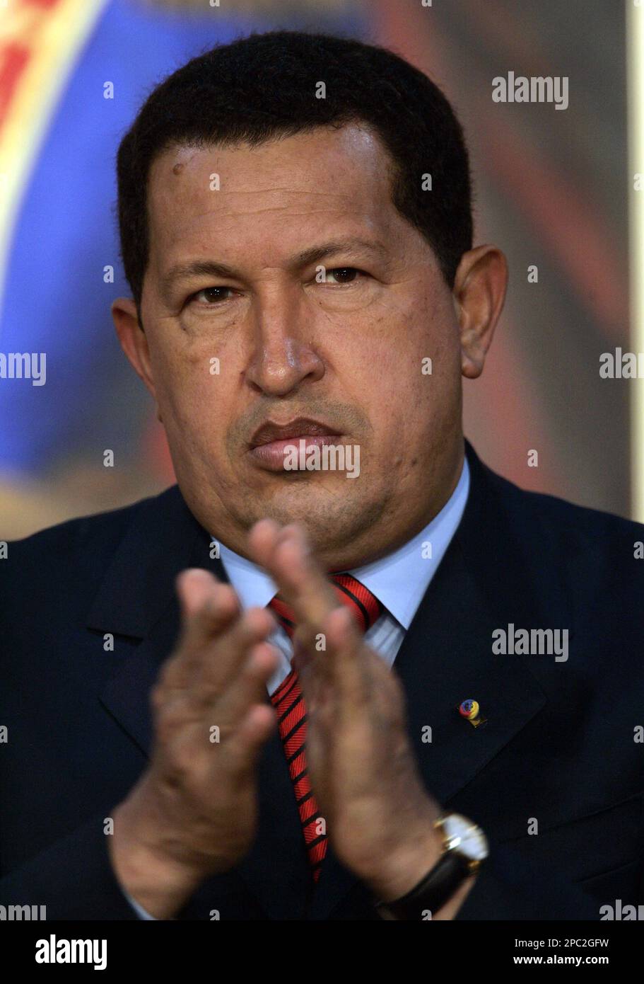 ** FILE ** In a file photo Venezuelan President Hugo Chavez applauds ...