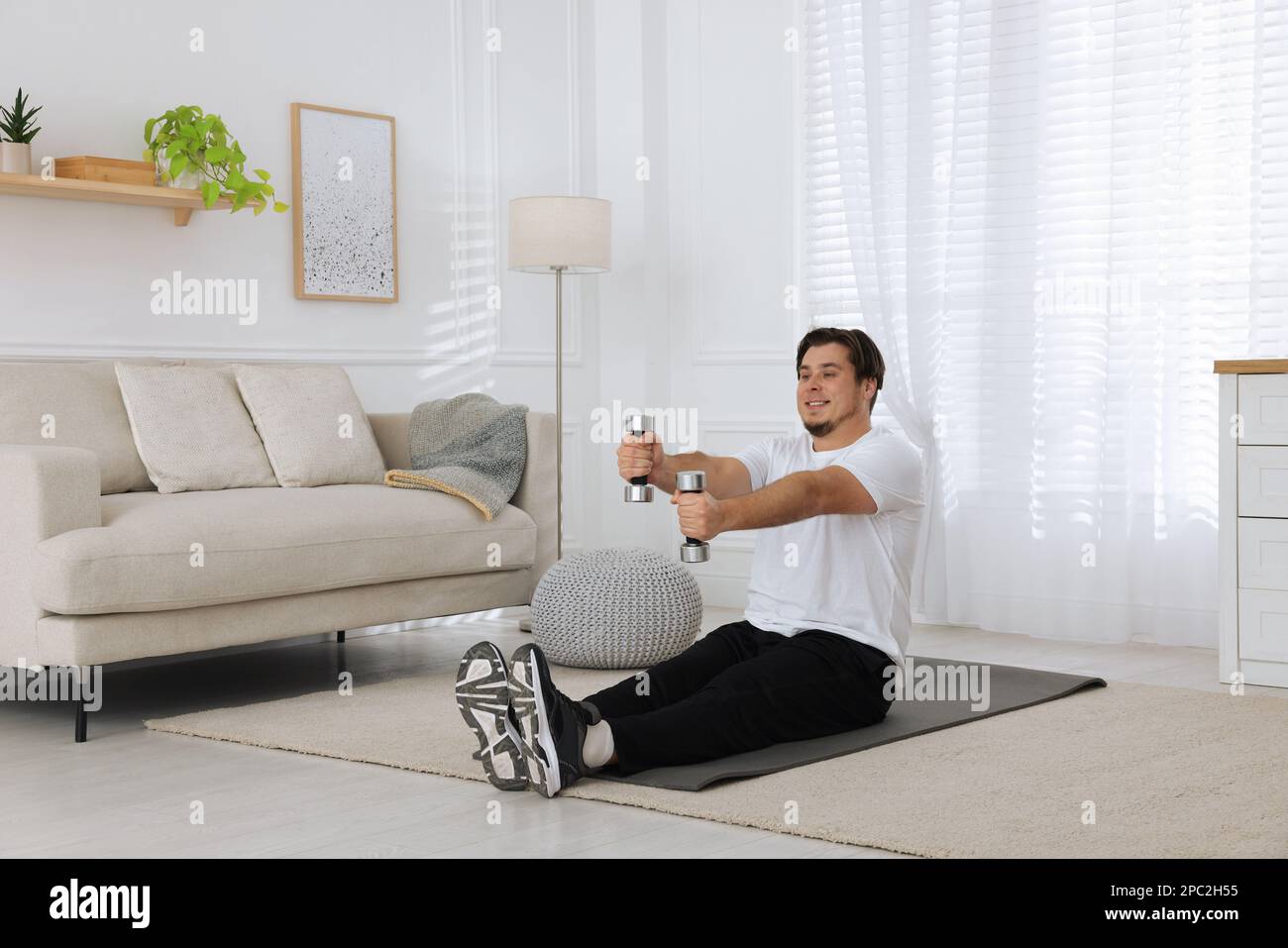Obese man doing yoga on mat hi-res stock photography and images - Alamy