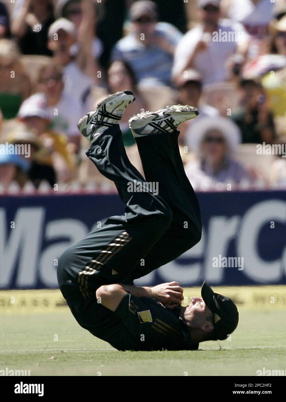 Australia's Stuart Clark rolls on the ground after catching out England ...