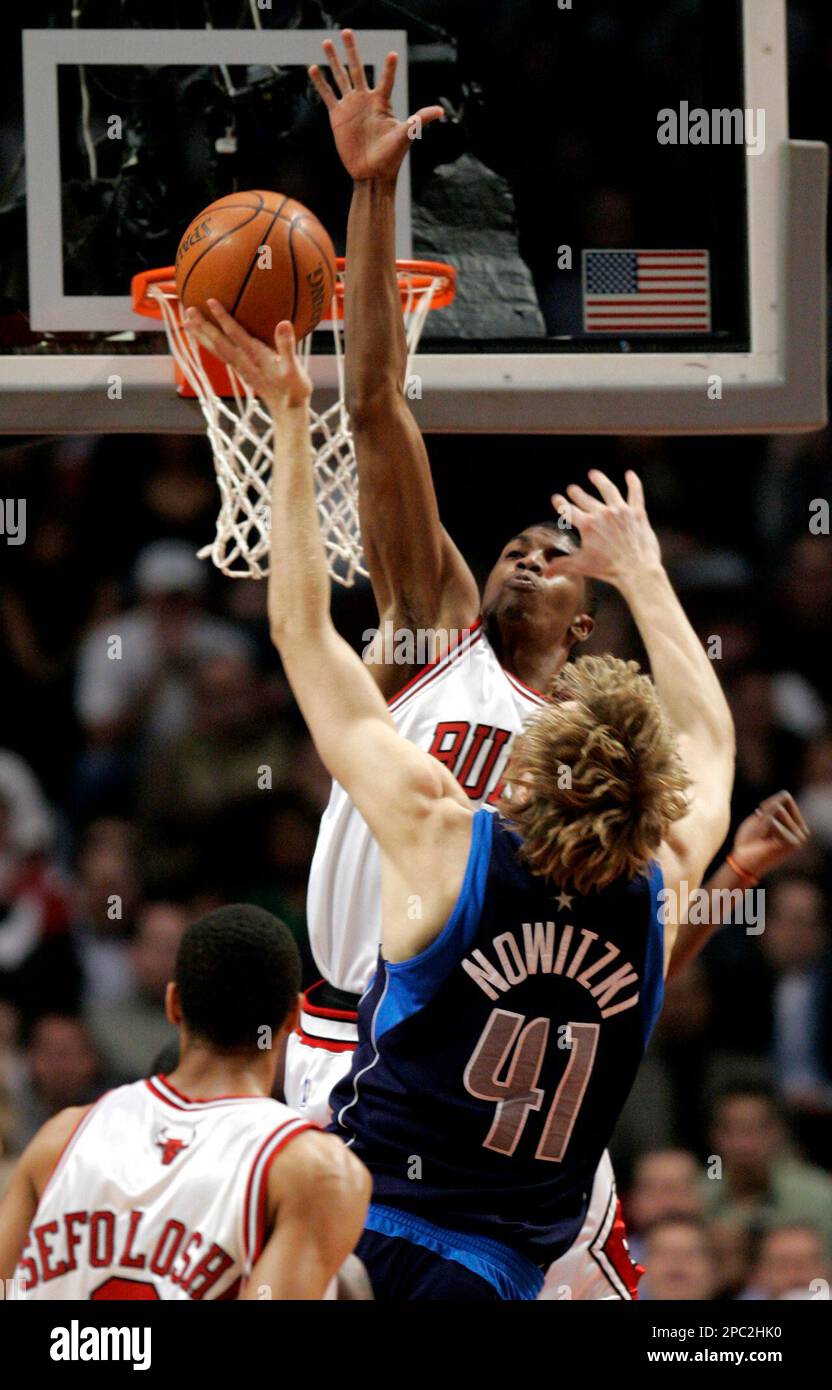 Chicago Bulls' Tyrus Thomas, top, blocks a shot by Dallas Mavericks ...