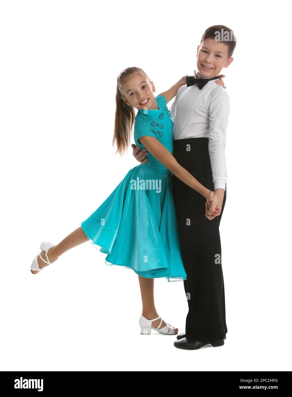 Beautifully dressed couple of kids dancing on white background Stock ...