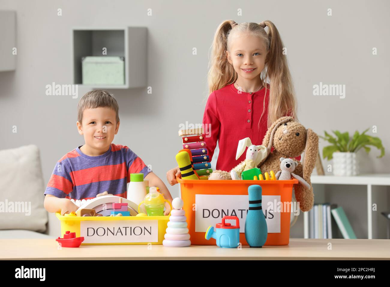 Cute little children sorting donation boxes at home Stock Photo - Alamy