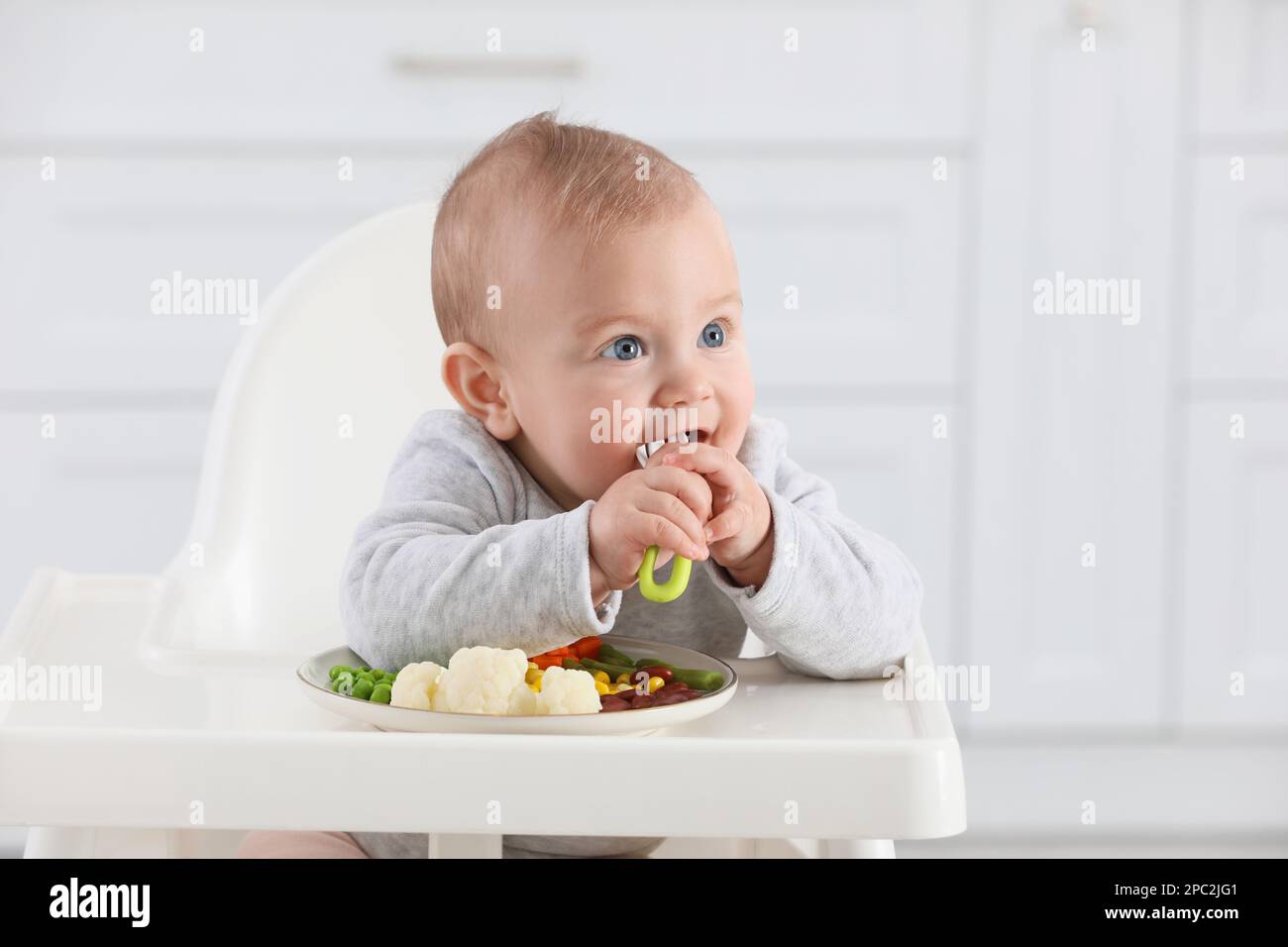 Cute little baby eating healthy food at home Stock Photo - Alamy