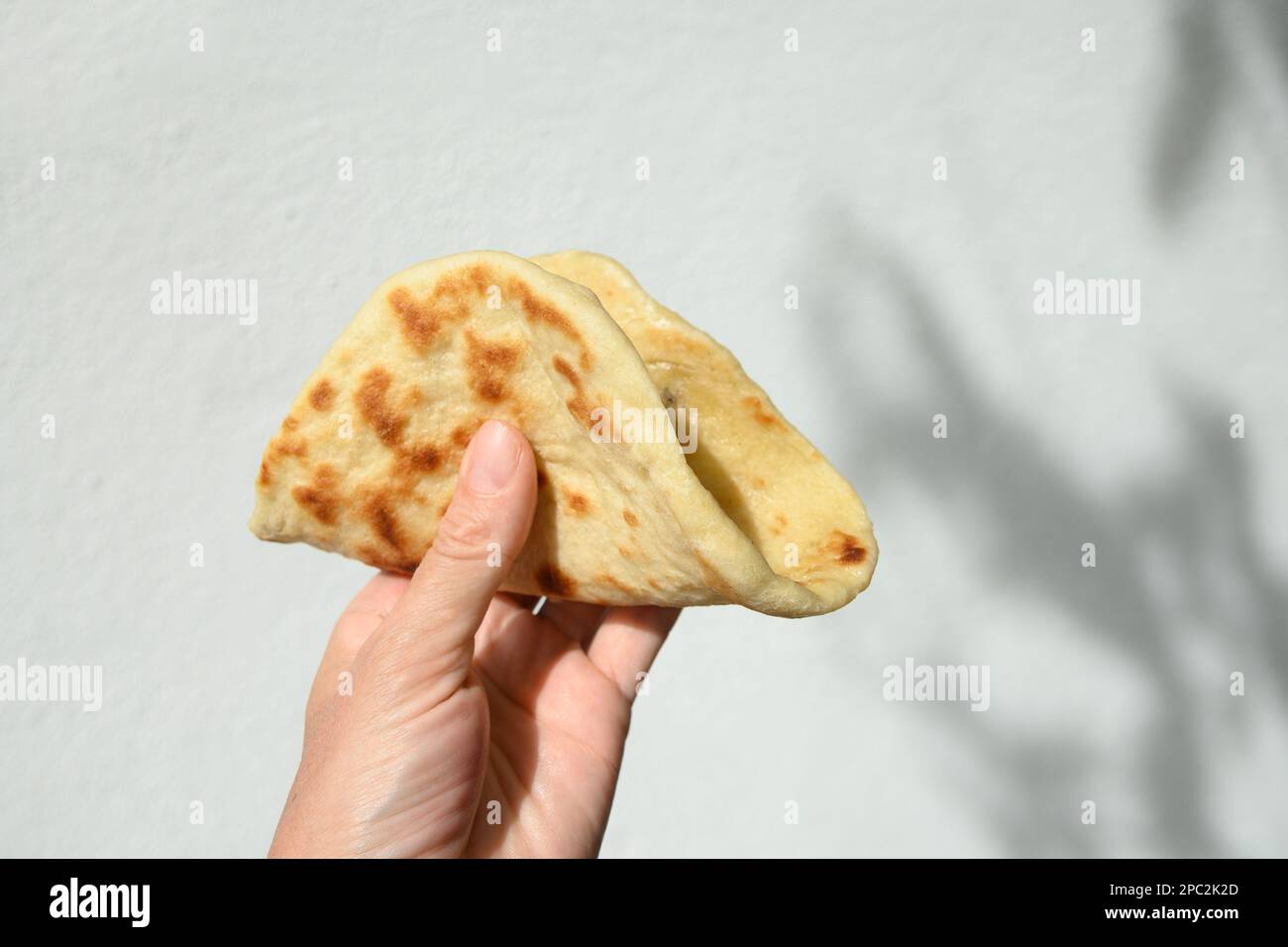 Authentic Sri Lankan Pol Coconut Roti in hand. Traditional recipe flat ...