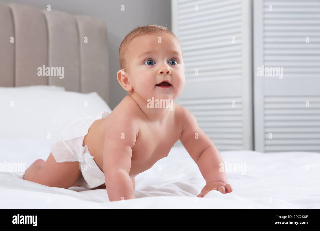 Cute baby in dry soft diaper on white bed at home Stock Photo - Alamy