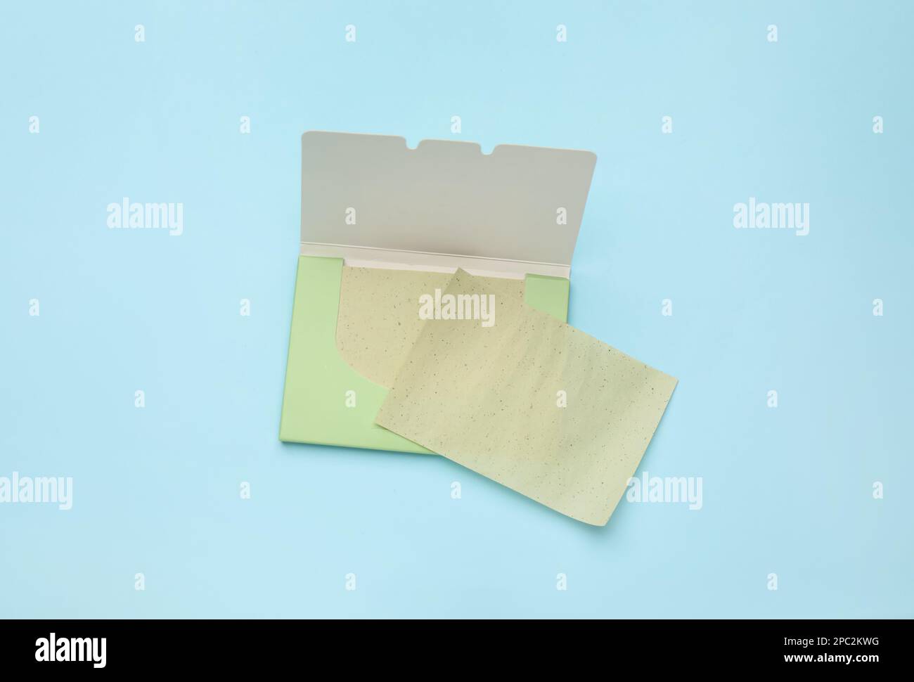 Facial oil blotting tissues on light blue background, flat lay ...