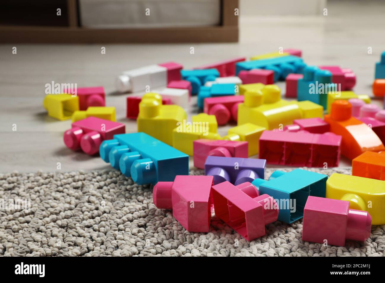 Colorful plastic building blocks on floor indoors, space for text Stock ...