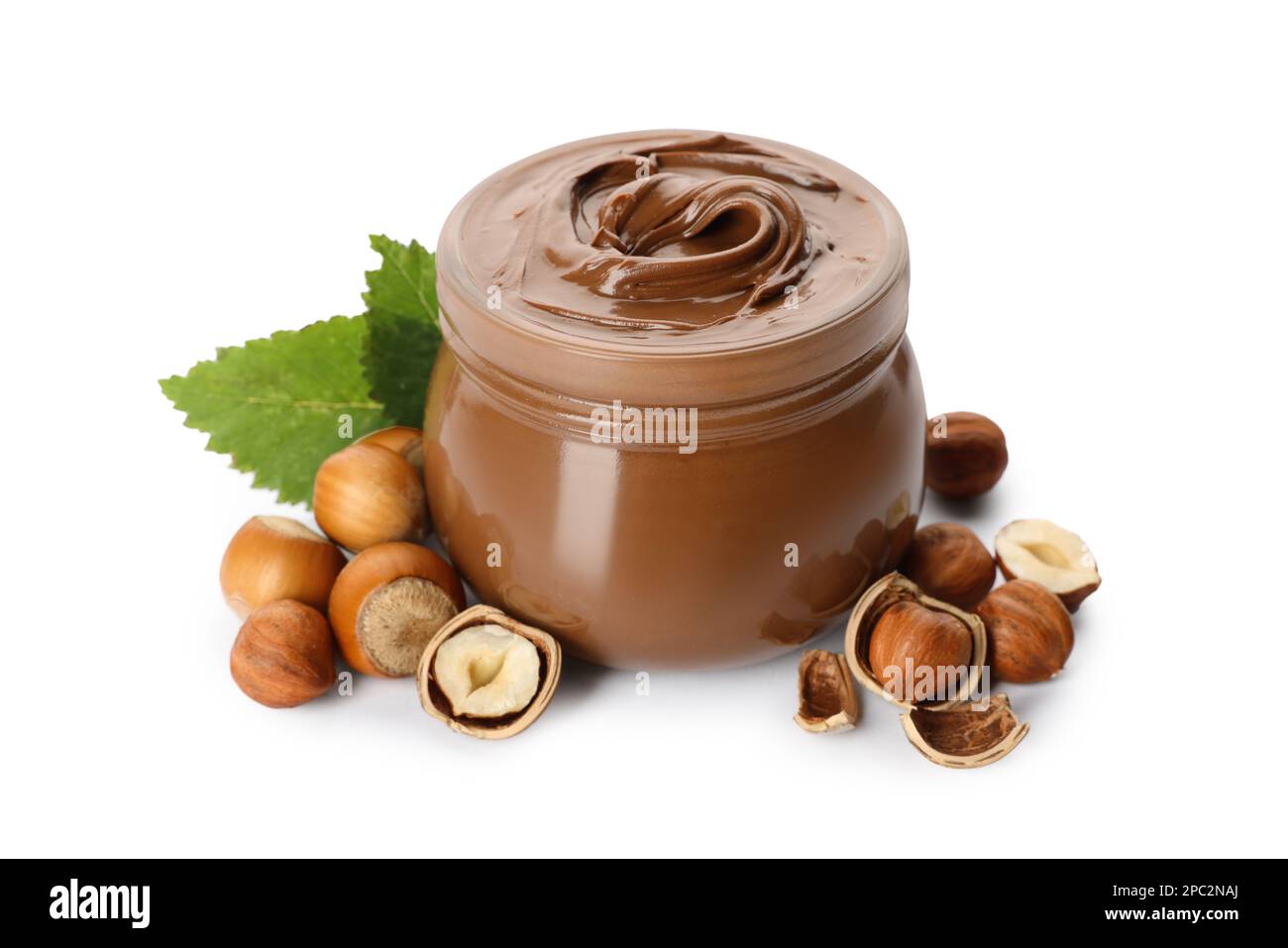 Glass jar with tasty chocolate hazelnut spread and nuts on white ...