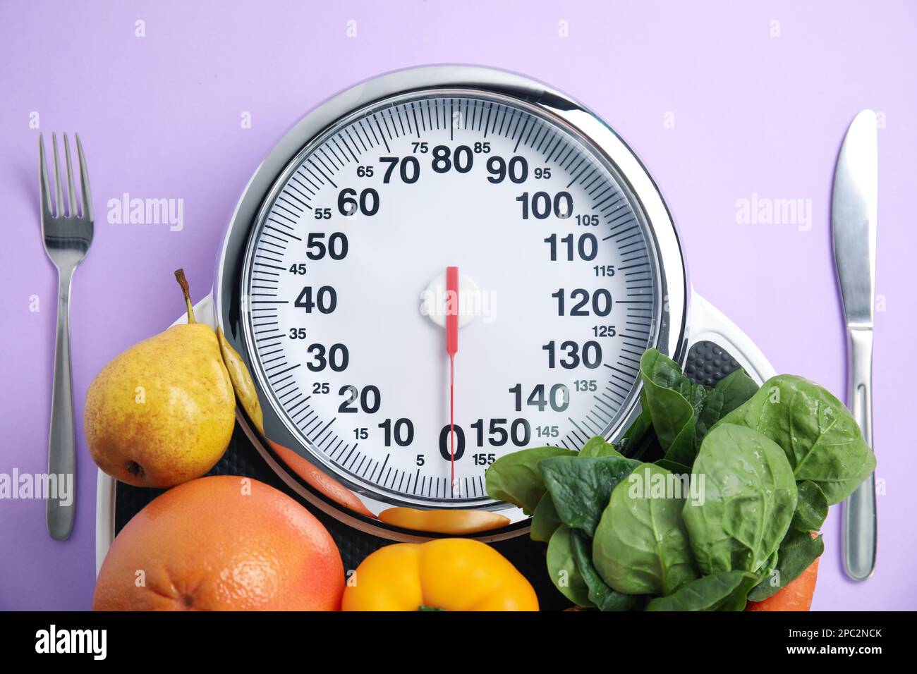 Scales, healthy food and cutlery on violet background, flat lay Stock ...